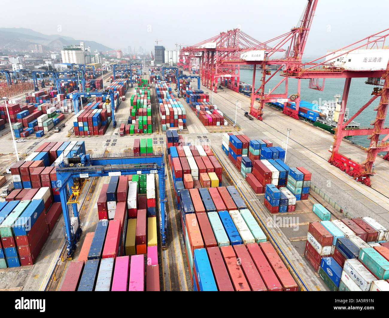 LIANYUNGANG, CHINA - MARCH 24, 2025 - Ocean cargo ships load and unload ...