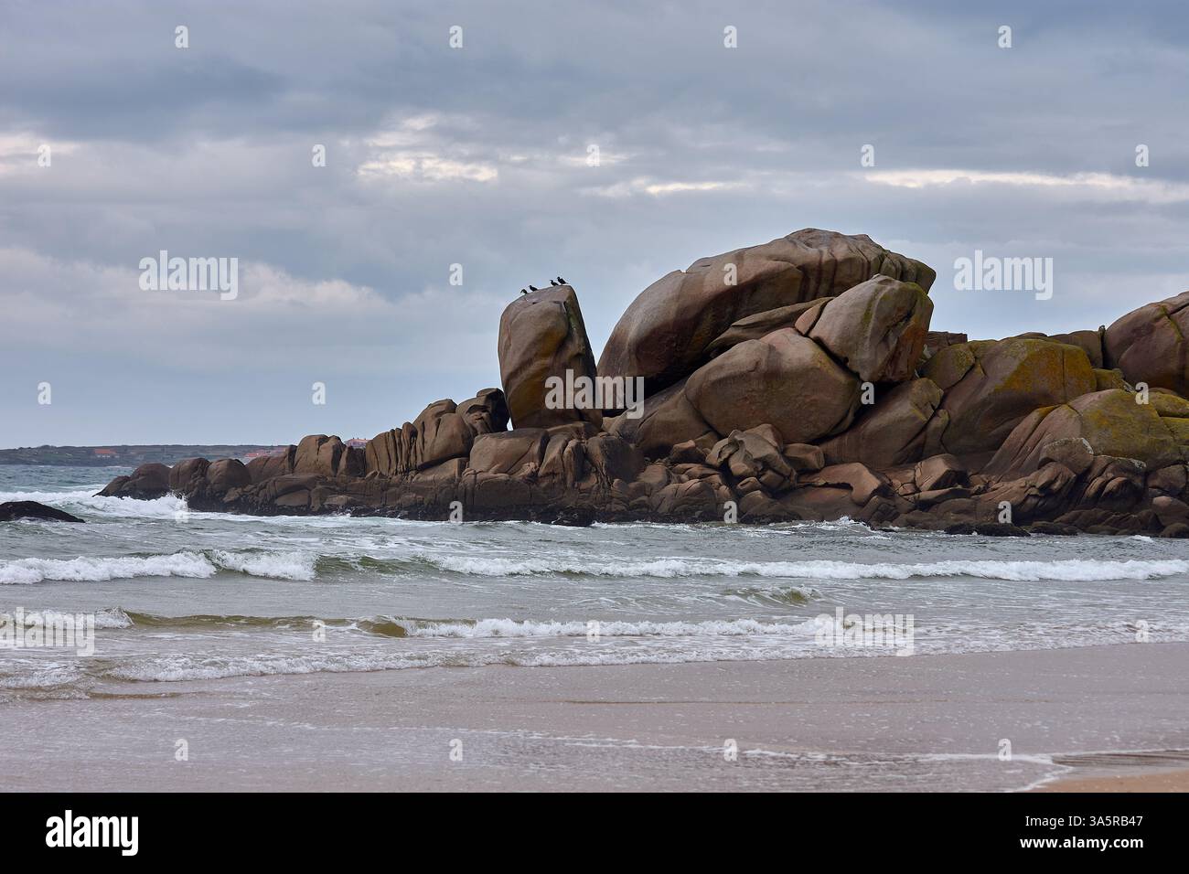 A striking rock formation stands prominently at Vilar Beach in ...