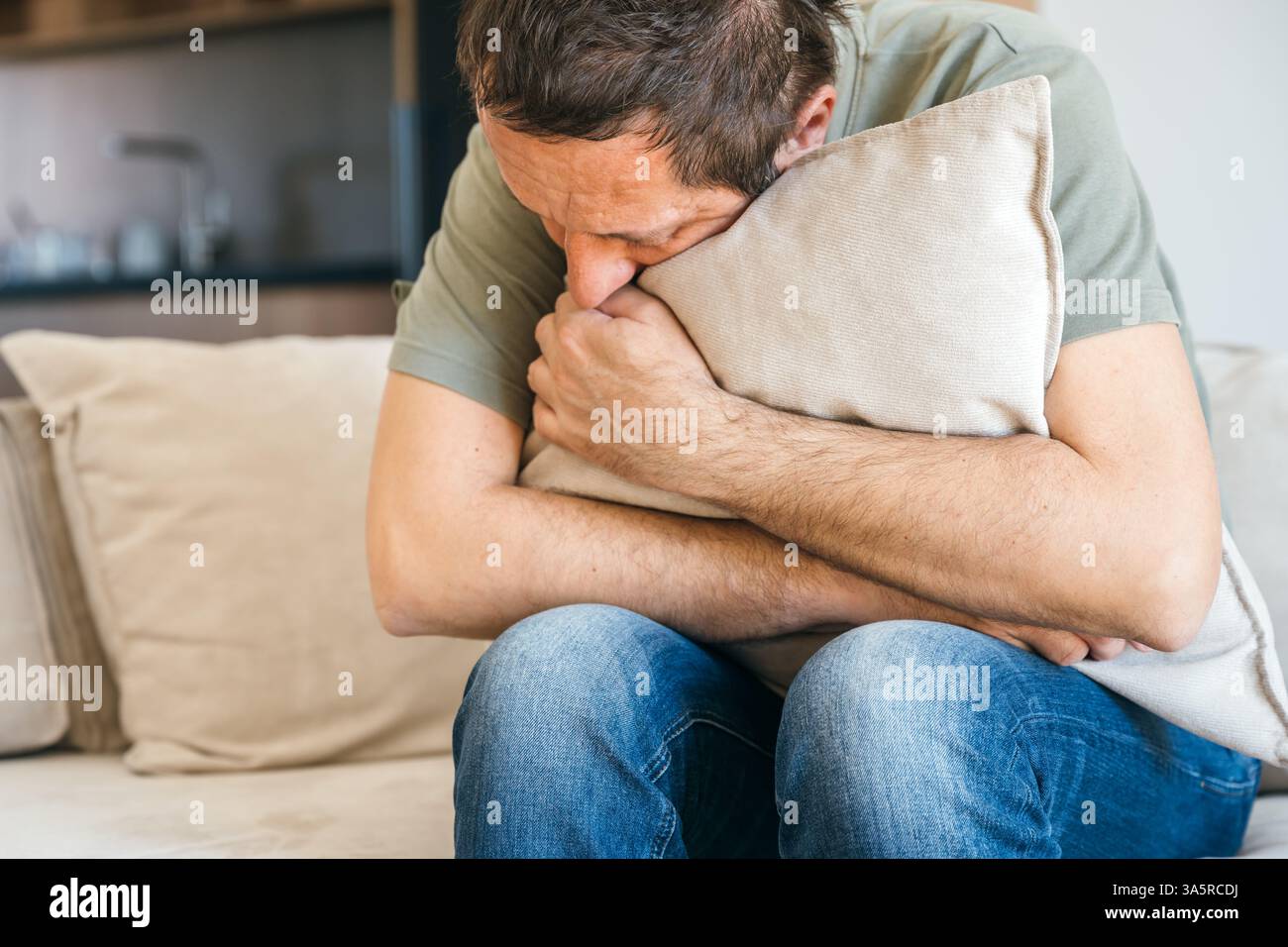 Sad unhappy man hugging pillow hi-res stock photography and images - Alamy