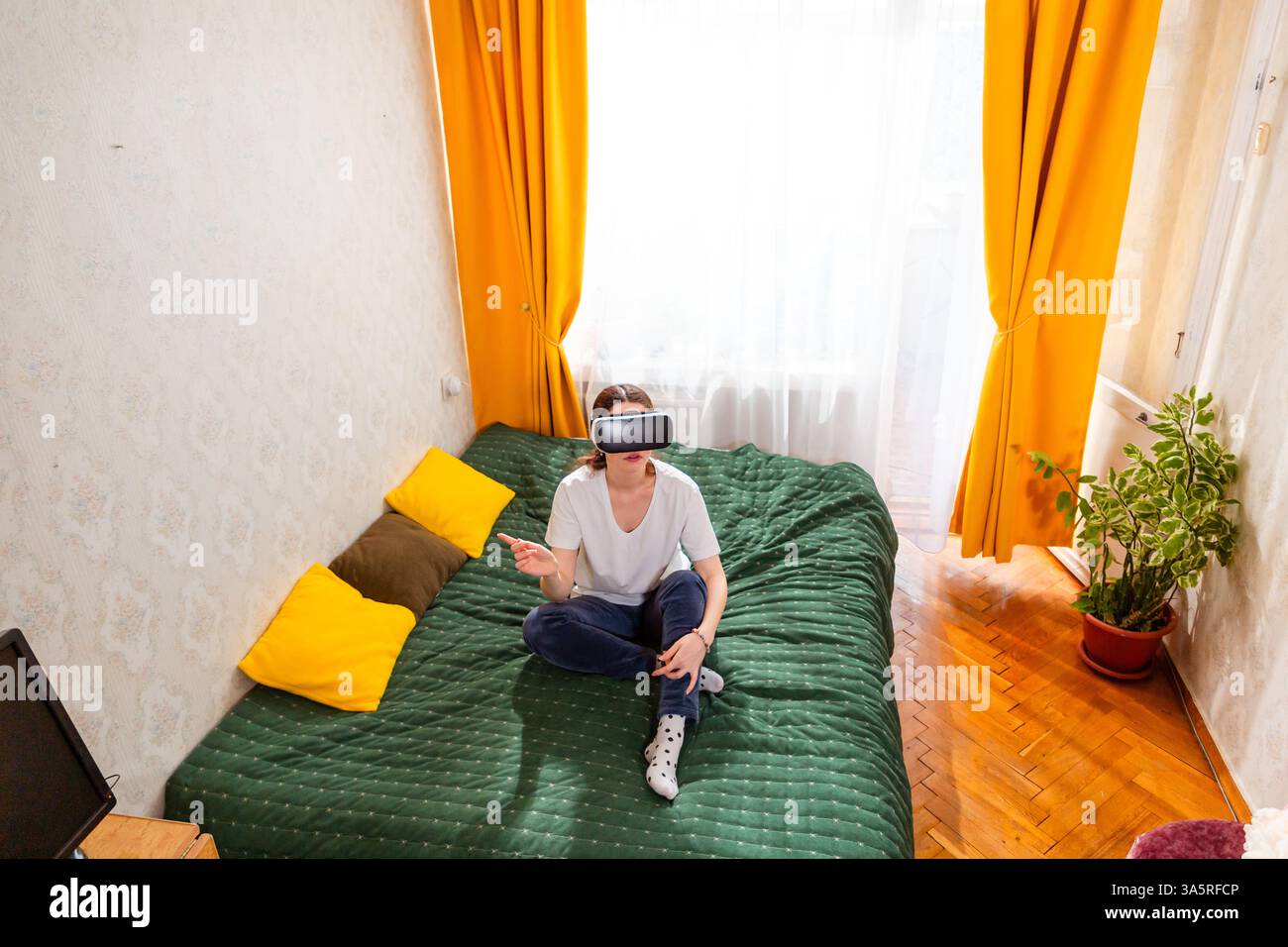 Female engaged in futuristic interactive content with VR headset. Wide ...