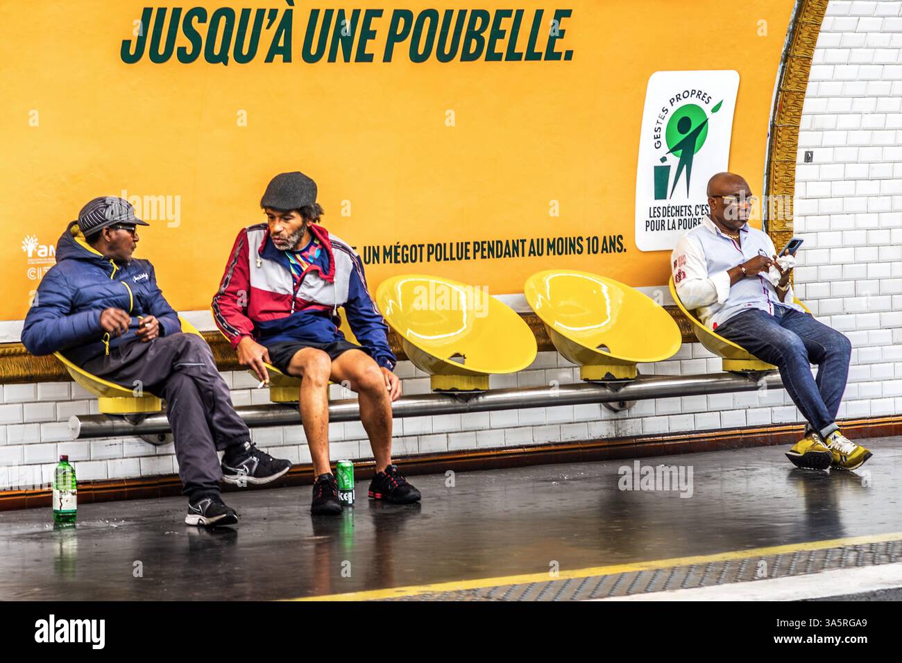 Three men, two talking and smoking, sitting on seats in the Metro ...