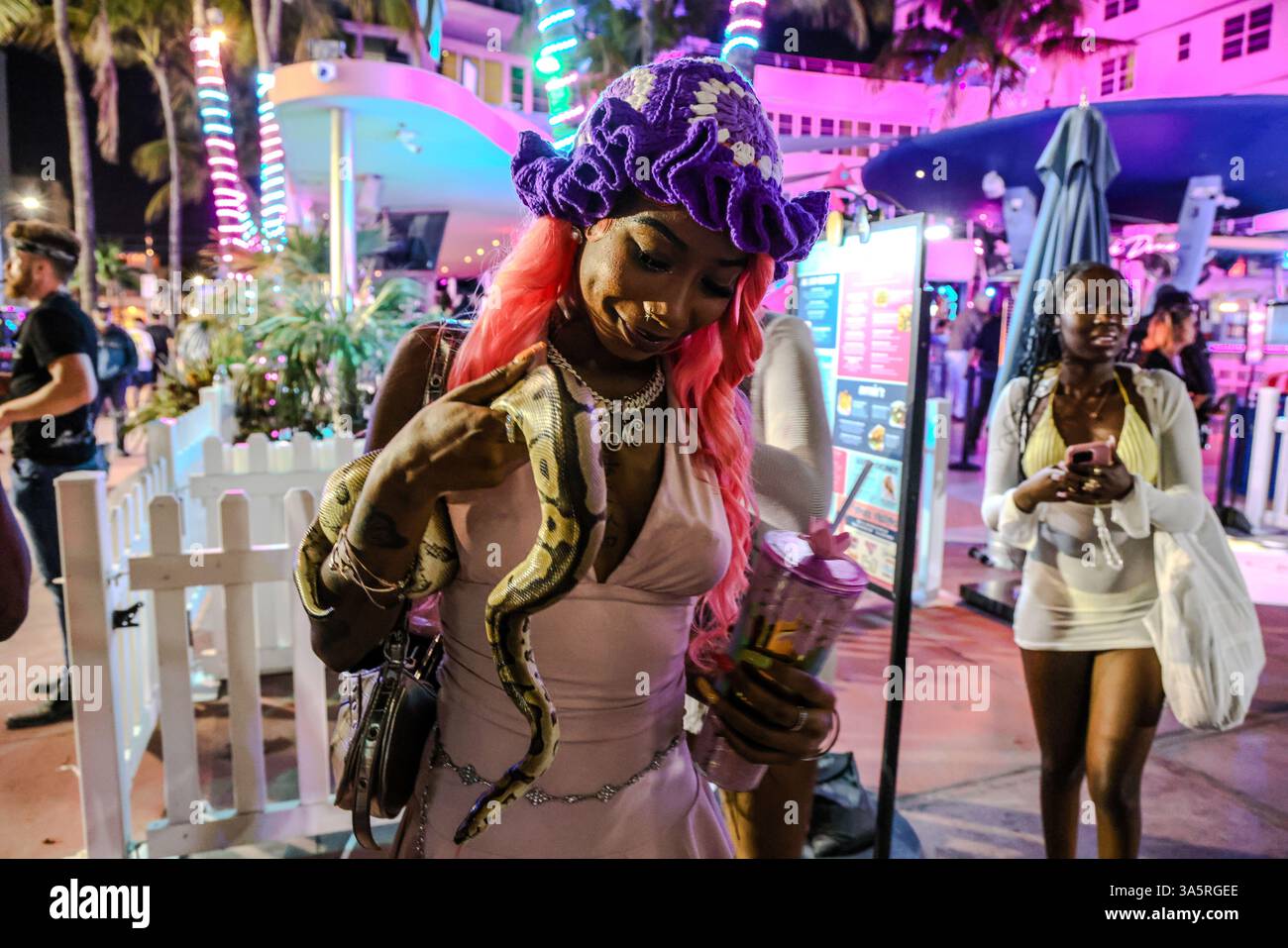 Miami Beach, Fl, USA. 22nd Mar, 2025. A woman with pink hair and purple ...