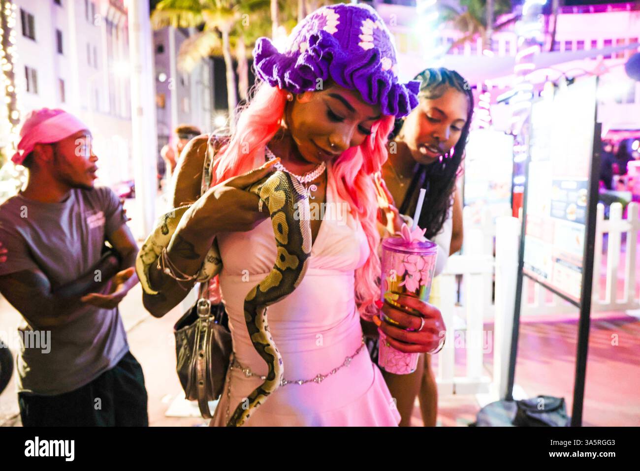 Miami Beach, Fl, USA. 22nd Mar, 2025. A woman with pink hair and purple ...
