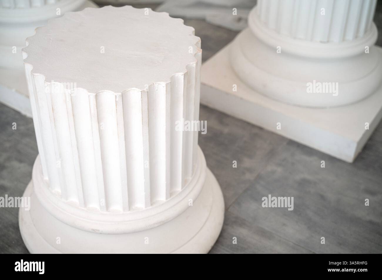 podium of antique plaster columns in the interior Stock Photo - Alamy