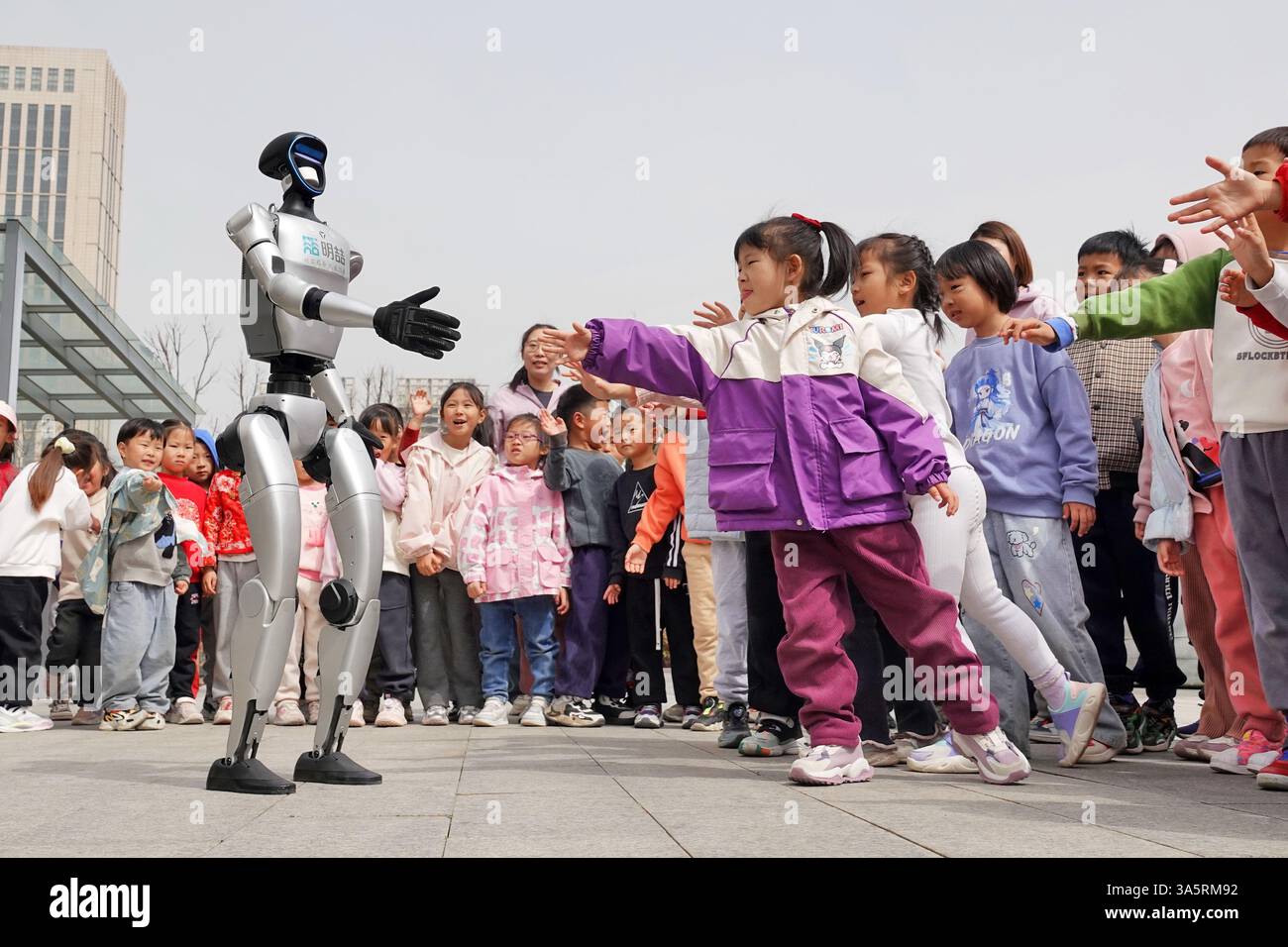 YANTAI, CHINA - MARCH 24, 2025 - A UNITREE G1 humanoid robot shakes ...