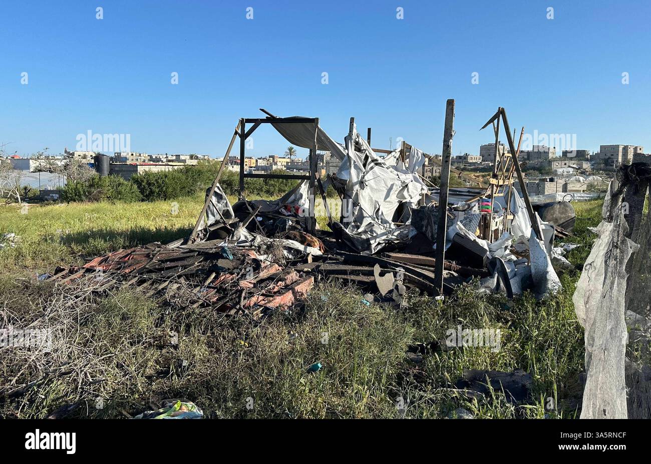Palestinians inspect the destruction after Israeli airstrike on tents ...