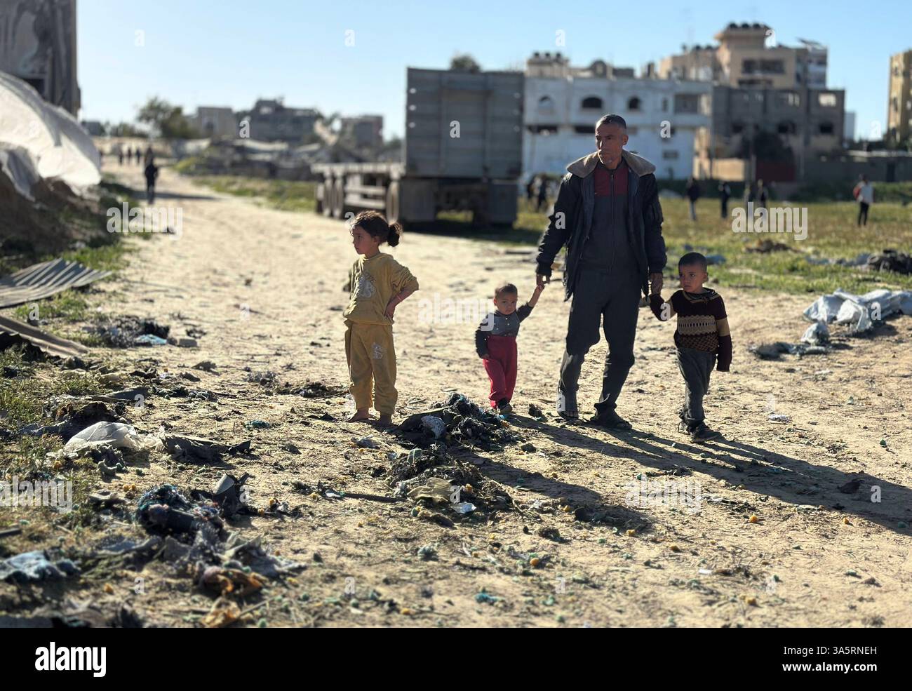 Palestinians inspect the destruction after Israeli airstrike on tents ...