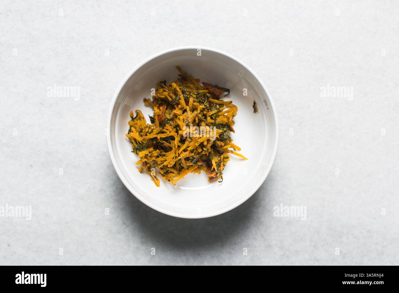 Overhead view of abacha or african salad in a white bowl, top view of ...