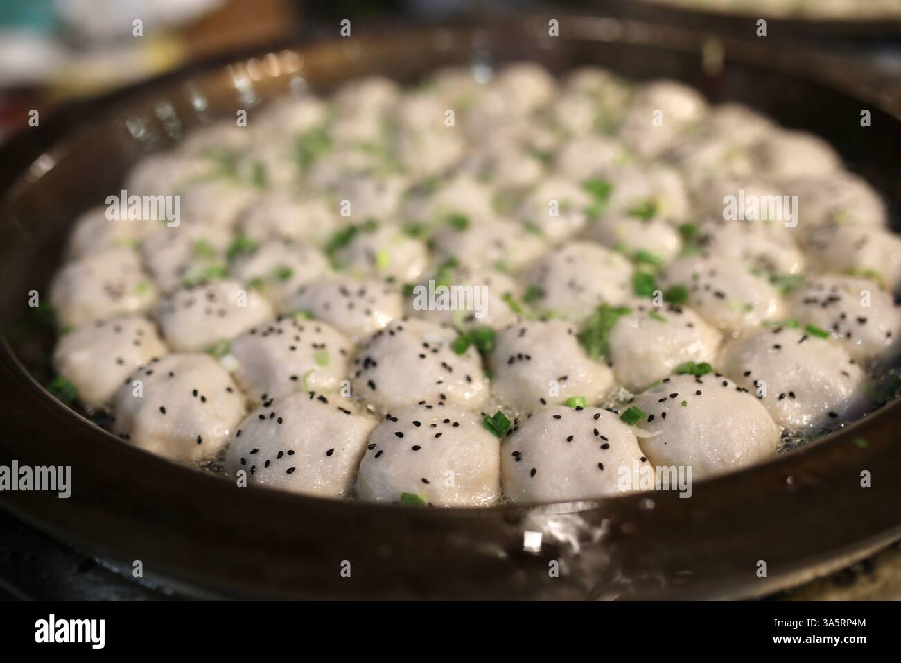 New York City, USA. 17th Feb, 2025. Dumplings are frying at a stand ...