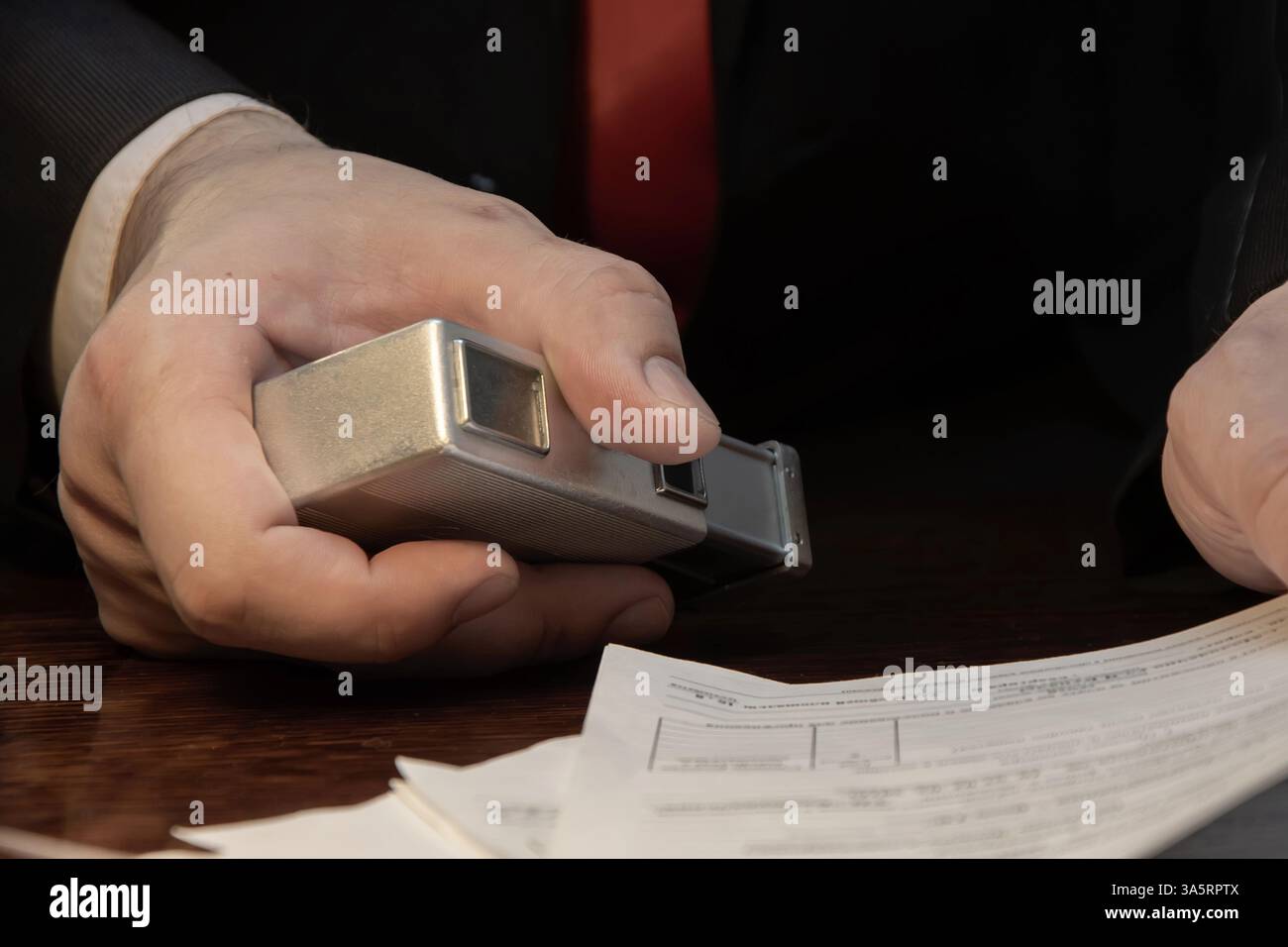 Spy camera in the hands of a spy , shooting secret documents ...