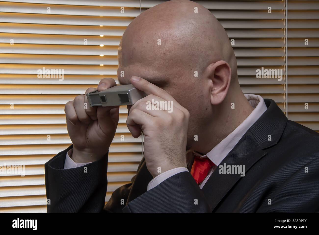 Spy photographs secret materials on a mini camera, collecting ...