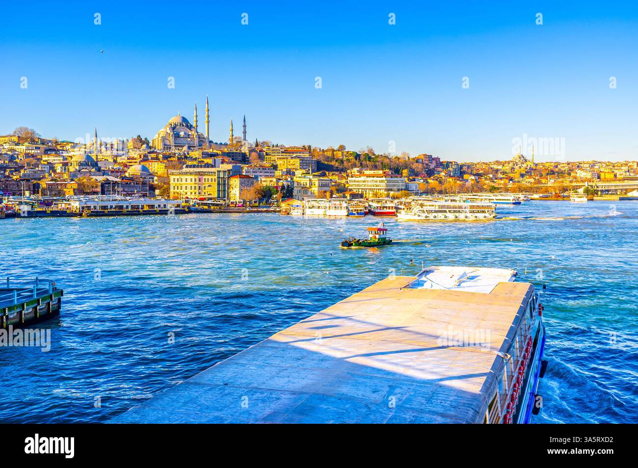 Passenger ferries sail along the Golden Horn Bay, passing scenic ...