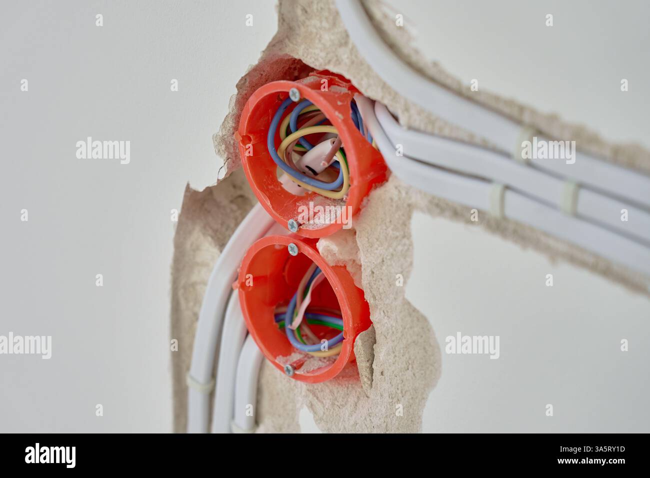 Electrical wiring installation during renovation. Plastic outlet boxes ...
