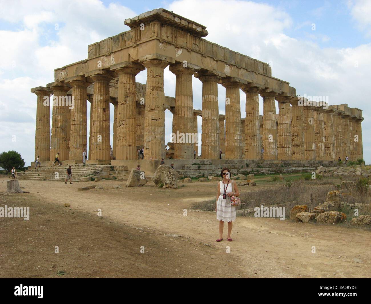 Explore the stunning ancient Greek temple ruins situated in Sicily with visitors admiring the ...
