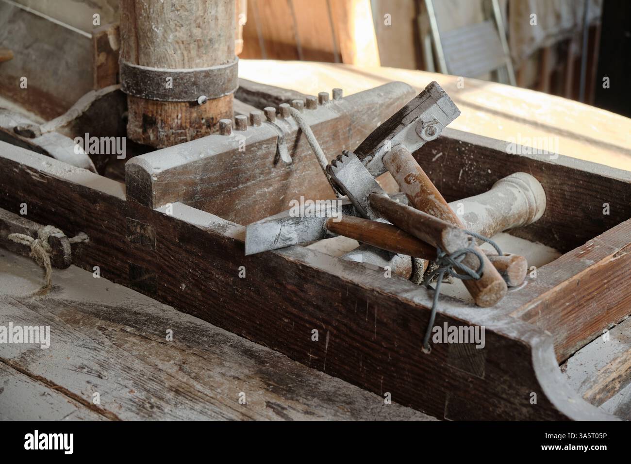 Close up on traditional millstone encased in wood inside a historic ...