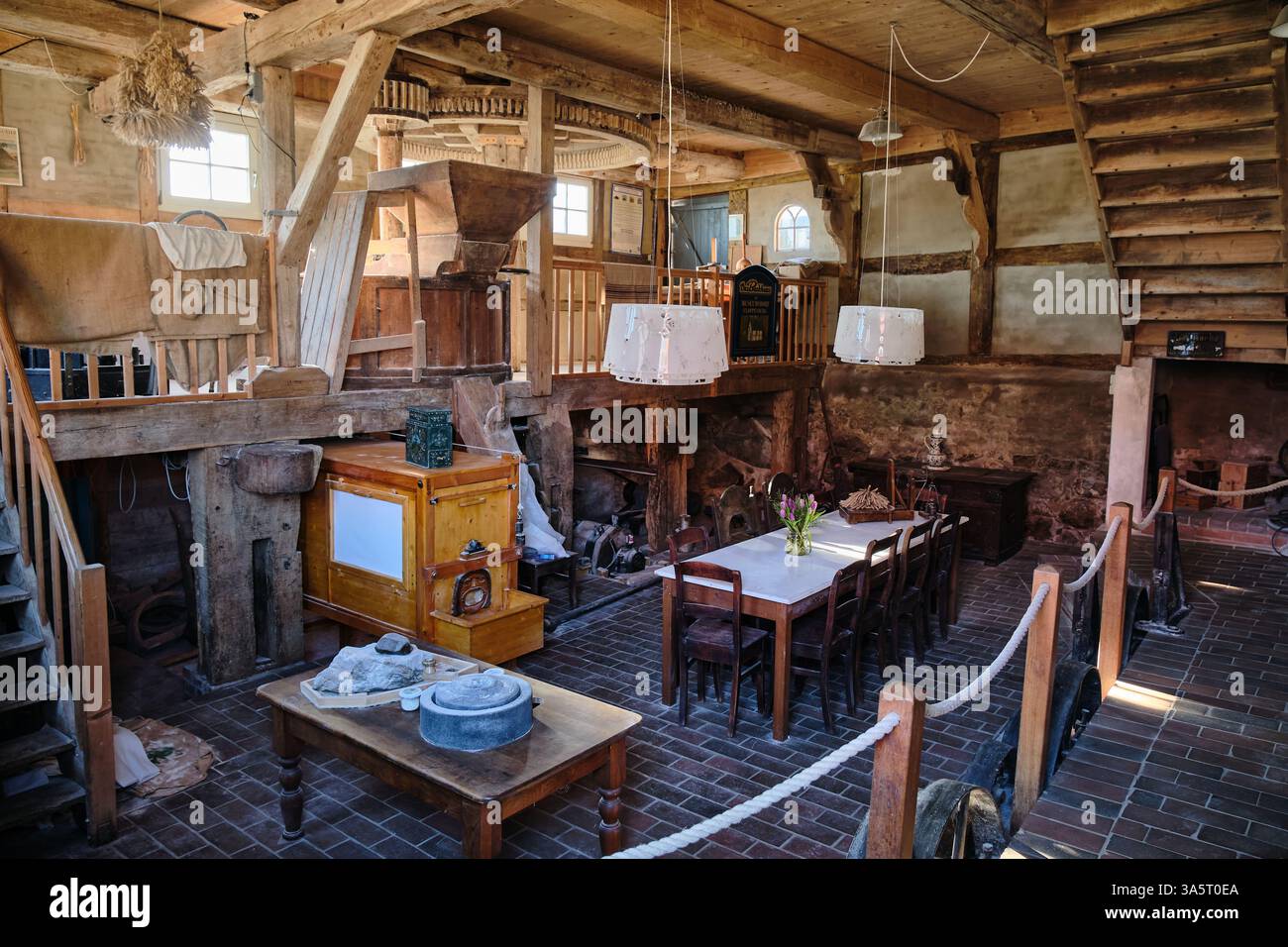 Rustic interior of a historic watermill with wooden beams, milling ...