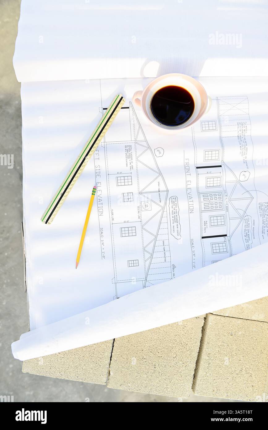 Blueprint with coffee, ruler, and pencil on a construction site Stock ...