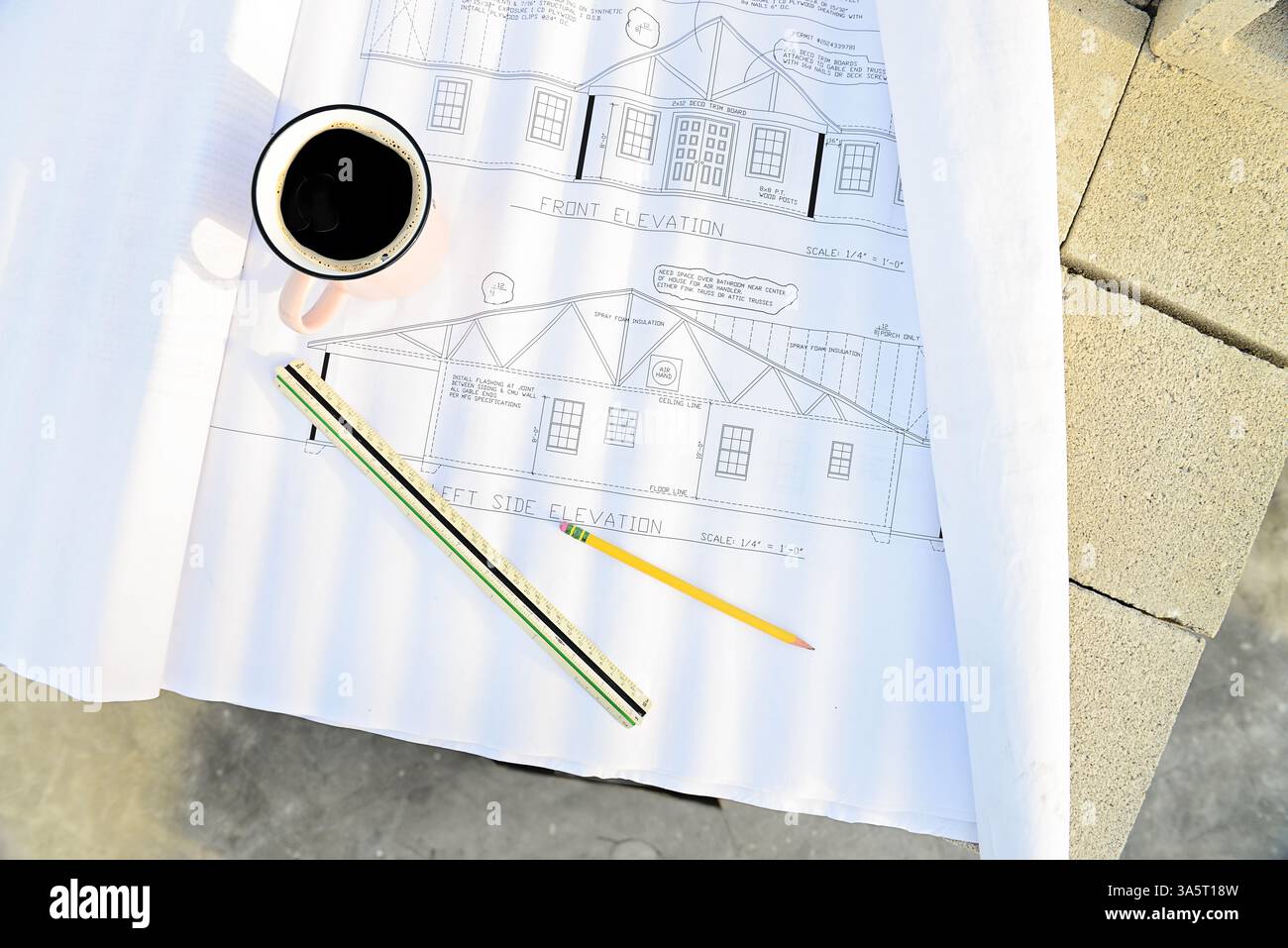 Blueprint with coffee, ruler, and pencil on a construction site Stock ...