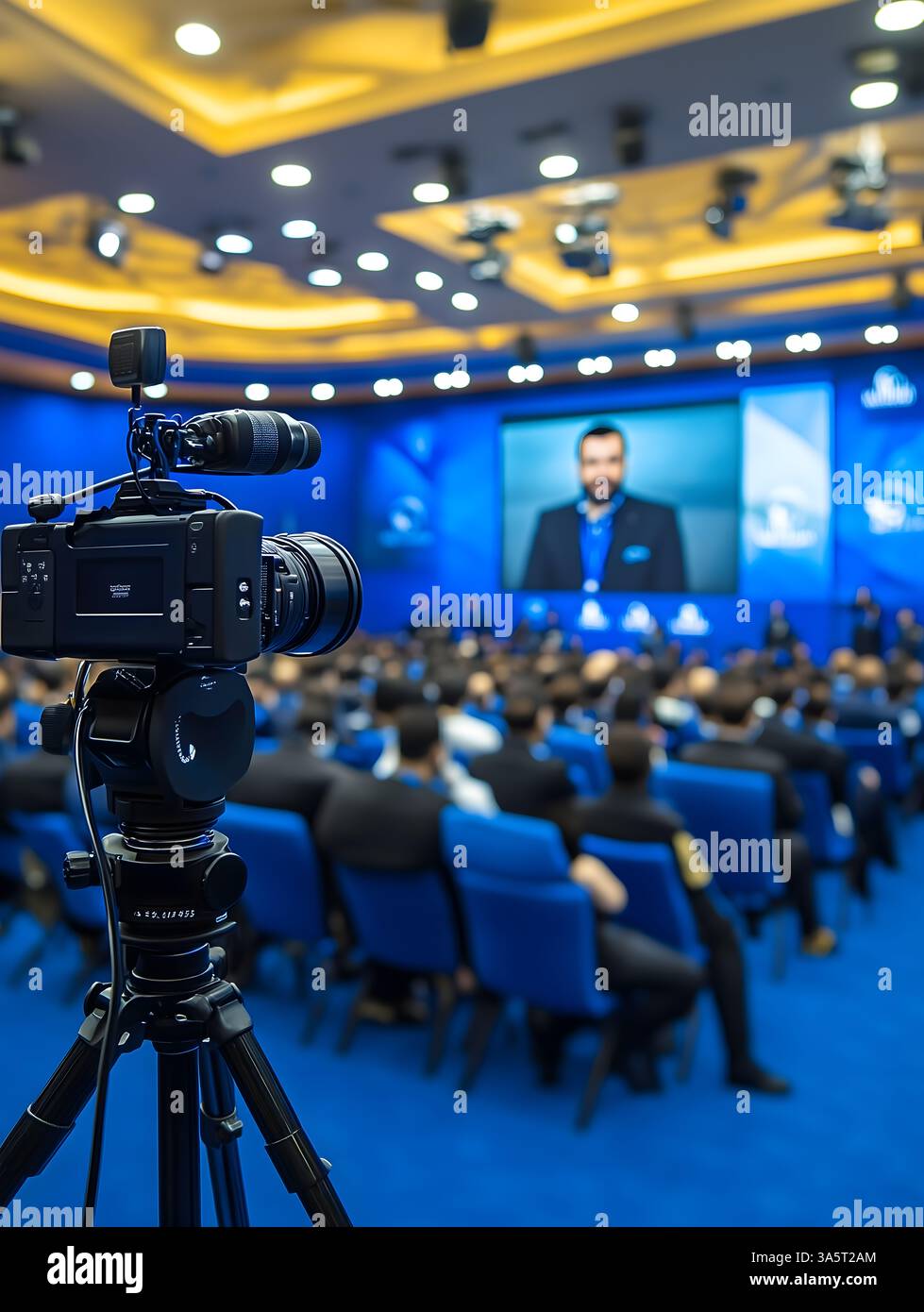 Business conference with video camera recording speaker on stage ...