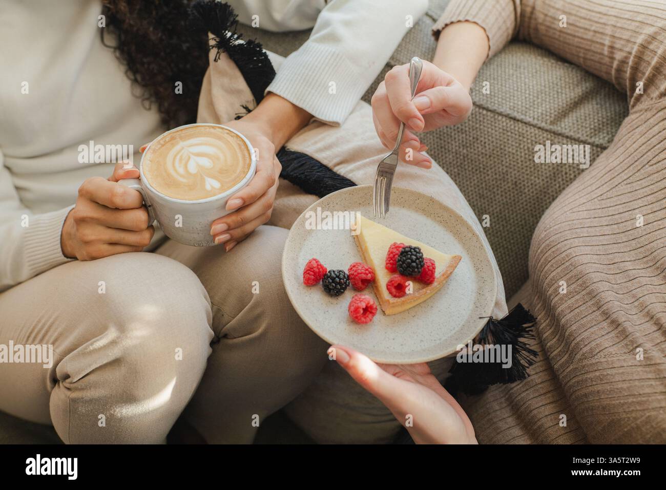 Friends sharing a Cozy Coffee and Dessert Moment Stock Photo - Alamy