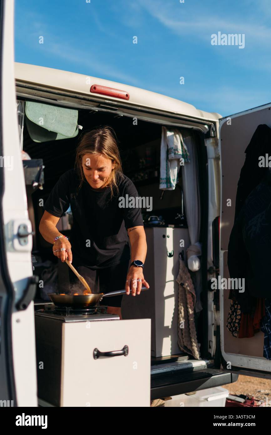 woman cooking a meal outside a camper van in nature Stock Photo - Alamy