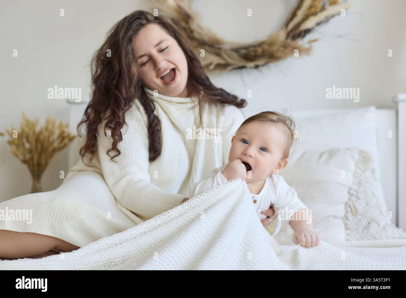Mother and baby playing under blanket hi-res stock photography and ...
