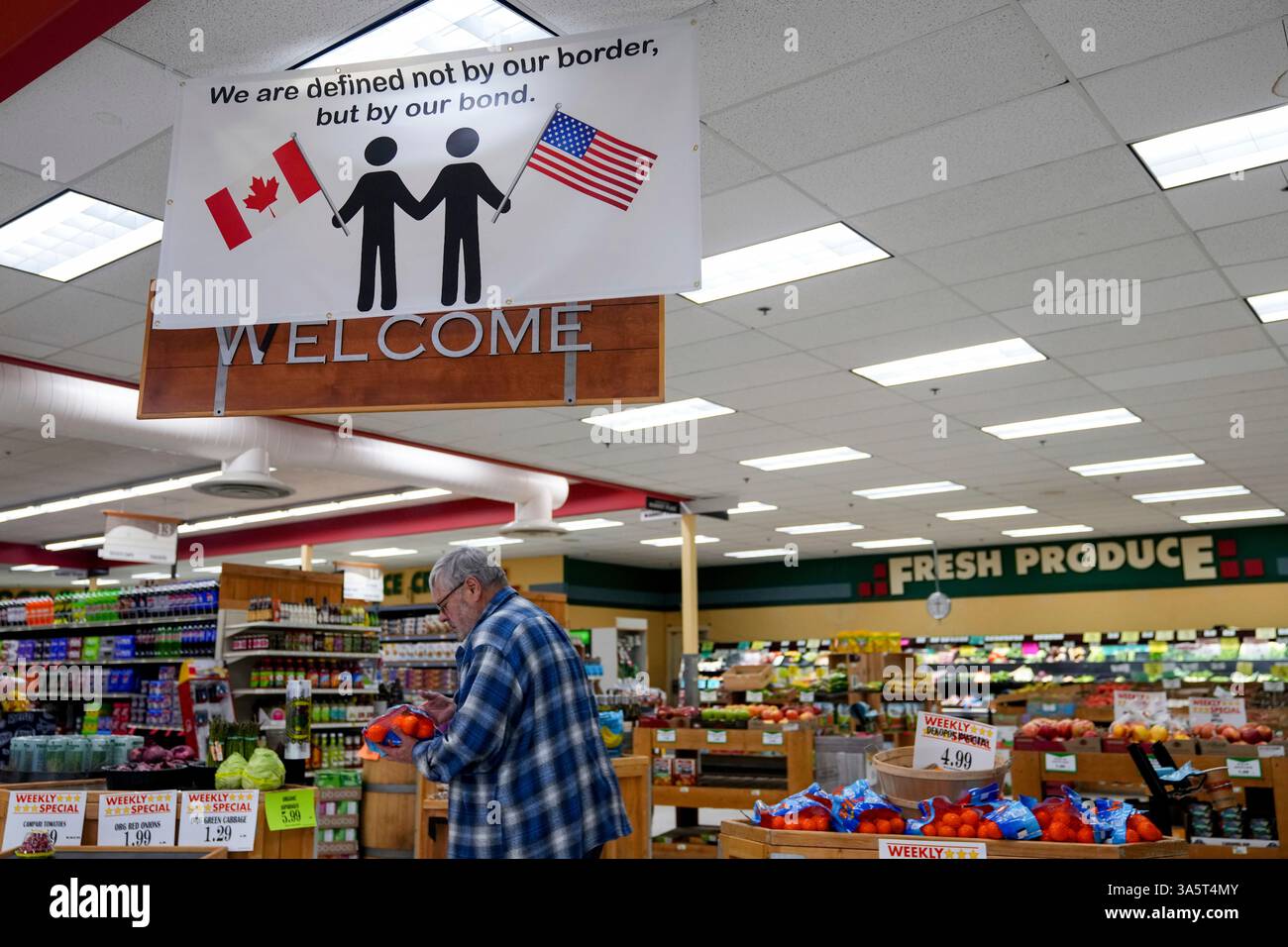 A shopper at the Point Roberts International Marketplace inspects a bag ...