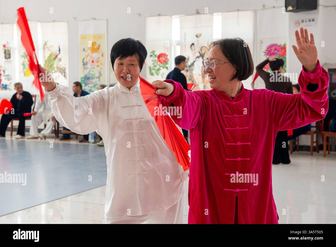 HAIAN, CHINA - MARCH 24, 2025 - Students practice Tai chi kung fu fans ...