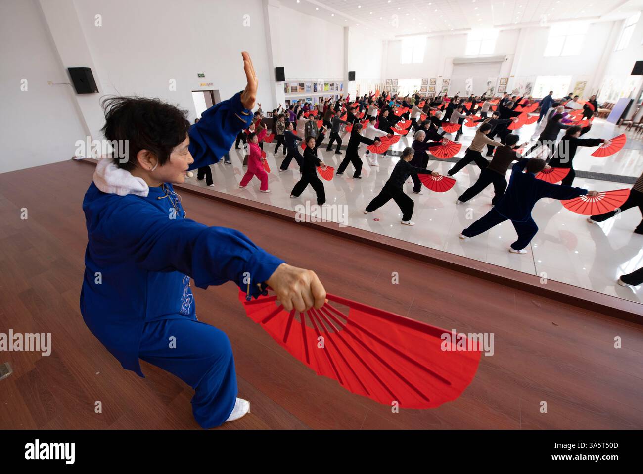HAIAN, CHINA - MARCH 24, 2025 - Students practice Tai chi kung fu fans ...