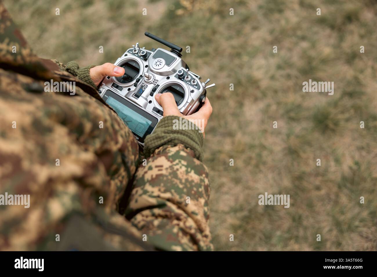 Drone control panel is in hand of military soldier. Artillery spotter ...