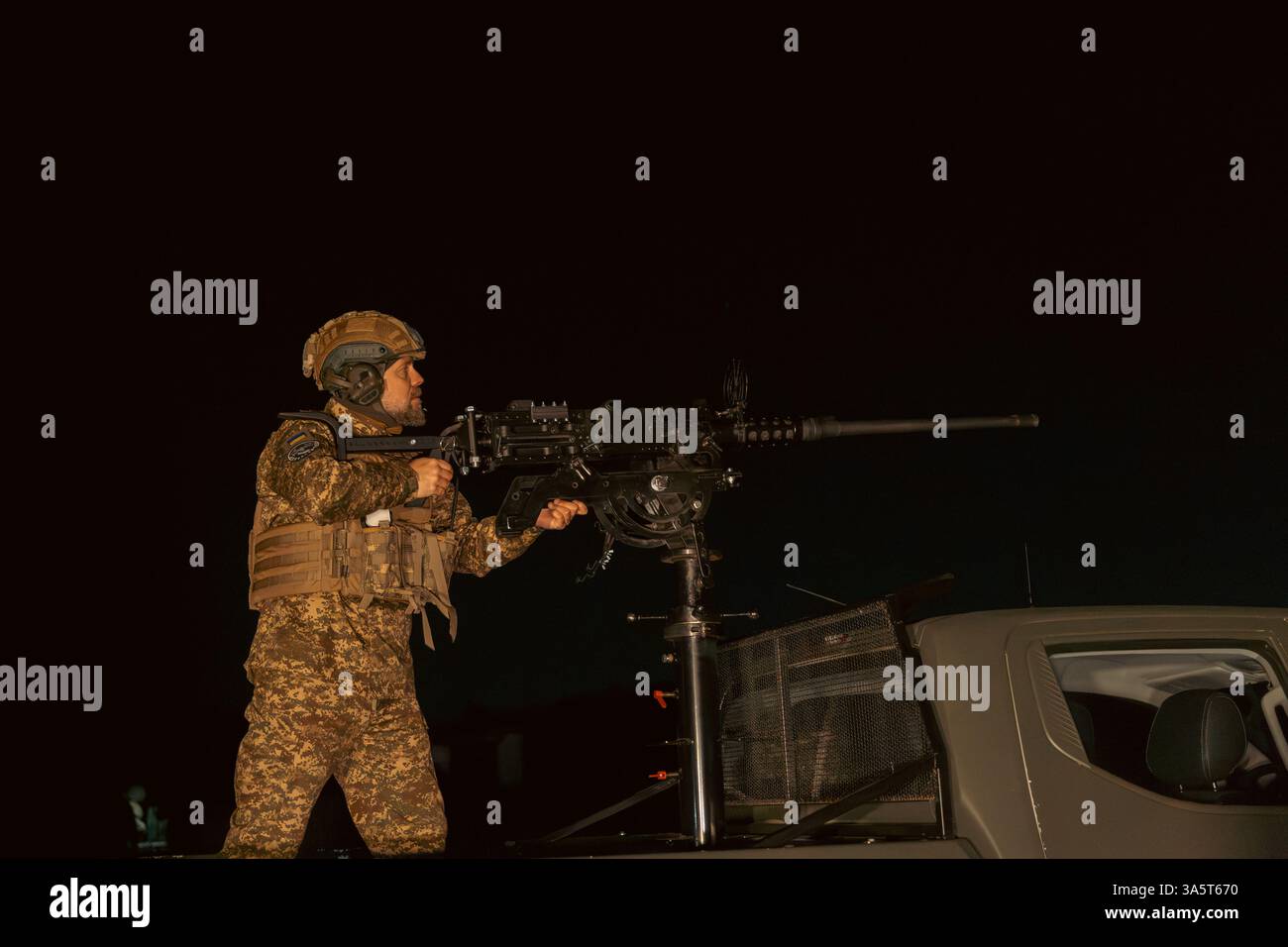 A soldier uses an anti-aircraft gun mounted on a pickup truck ...