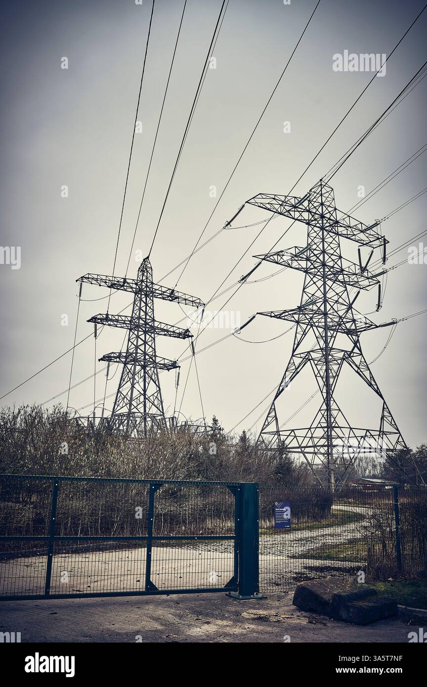 Two electricity pylons and power lines against the sky at sub station ...