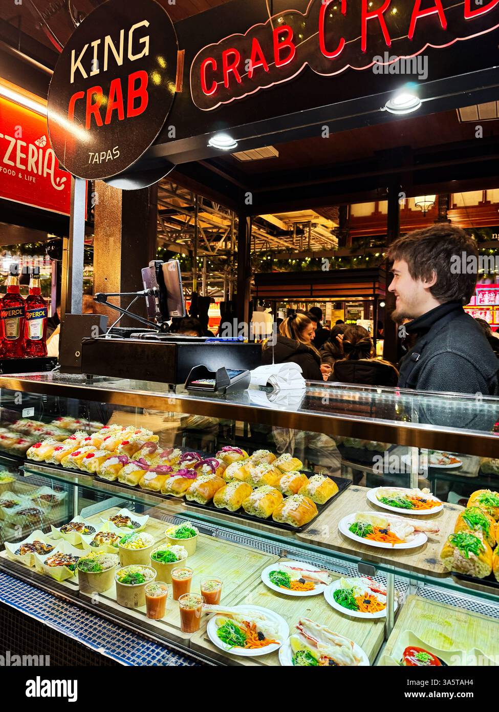 Madrid, Spain - December 28, 2023: A vibrant seafood tapas counter in ...