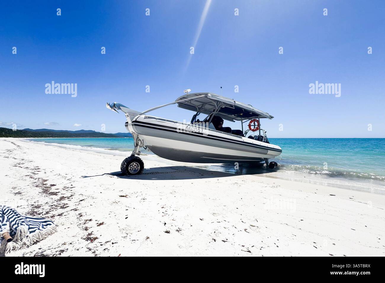 Boat on wheels standing at unique famous Whitehaven Beach. Modern ...