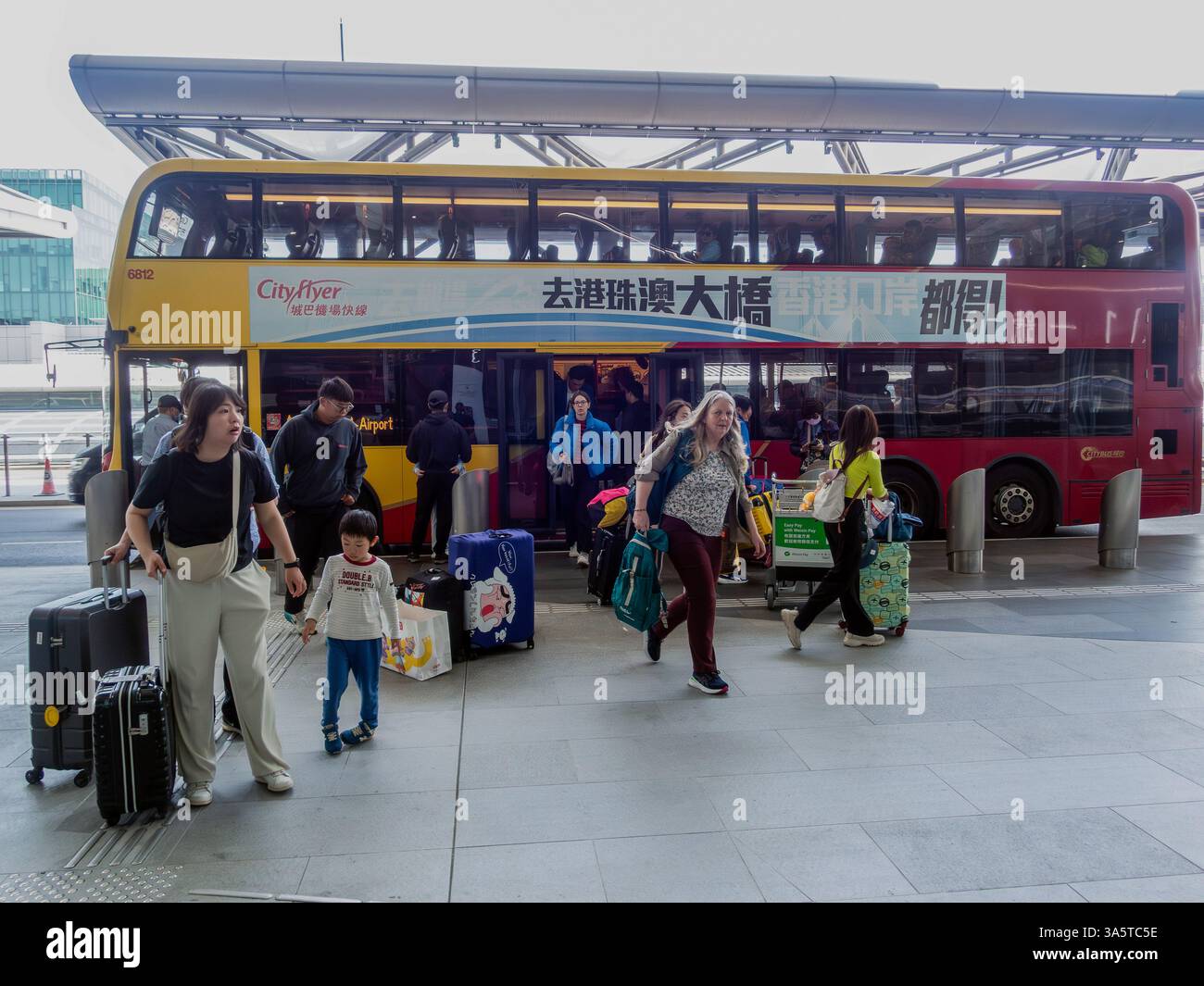 Hong Kong, China. 23rd Mar, 2025. Passengers are seen taking the bus to Hong Kong International ...