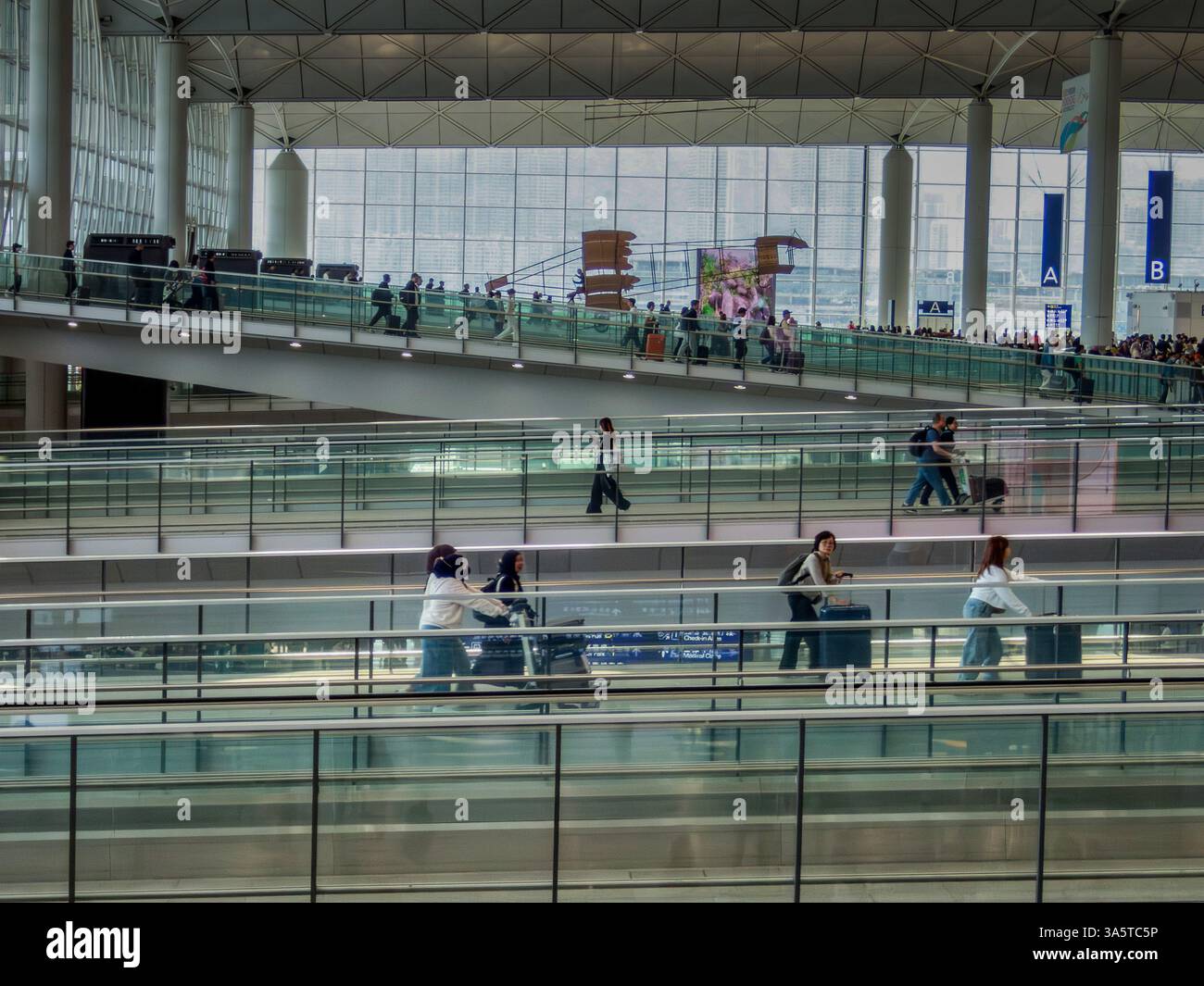Hong Kong, China. 23rd Mar, 2025. Flight passengers are seen walking in the departure hall at ...