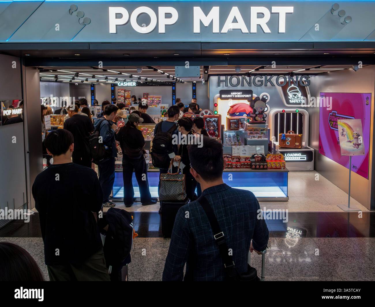 Hong Kong, China. 23rd Mar, 2025. Passengers are seen at the Pop Mart store in the departure ...