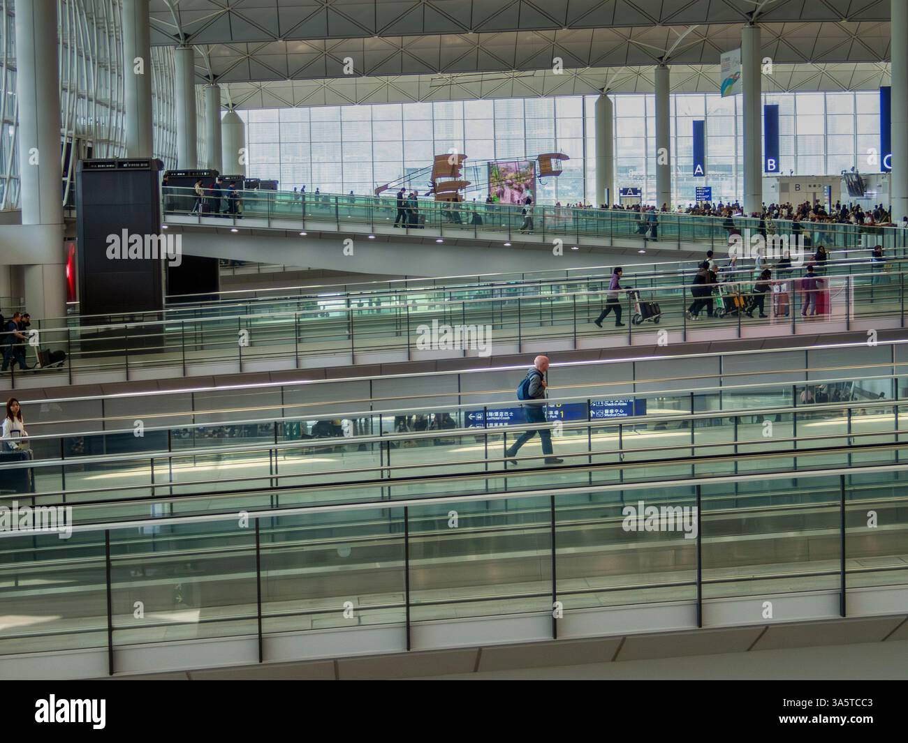 Hong Kong, China. 23rd Mar, 2025. Flight passengers are seen walking in the departure hall at ...
