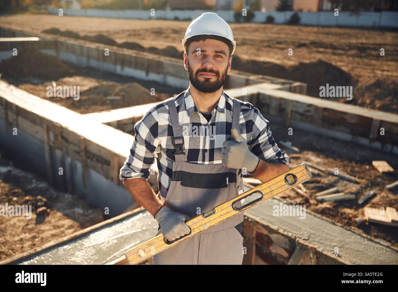 Tool for measuring leveling of surface. Worker is on the construction ...