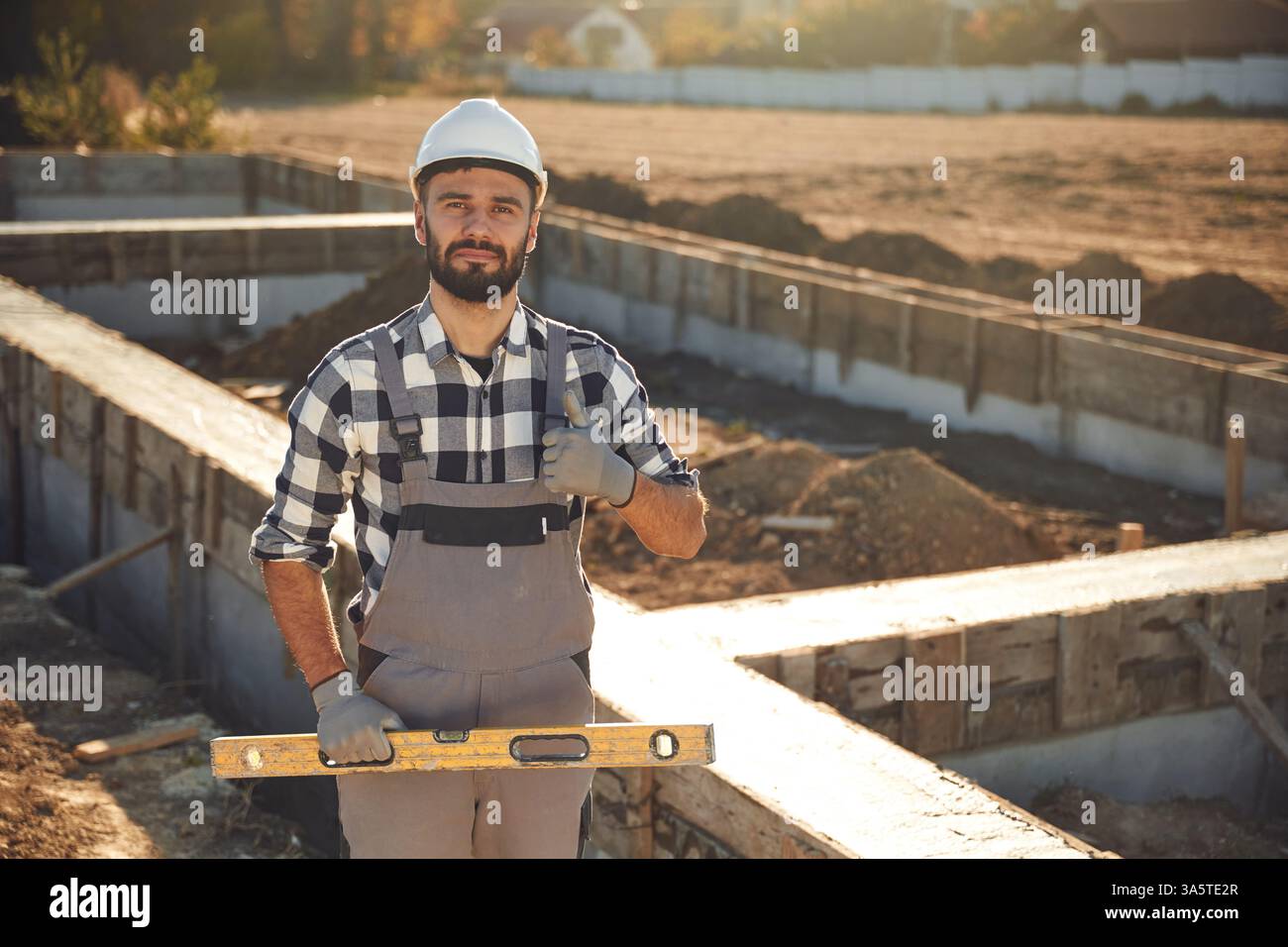 Tool for measuring leveling of surface. Worker is on the construction ...