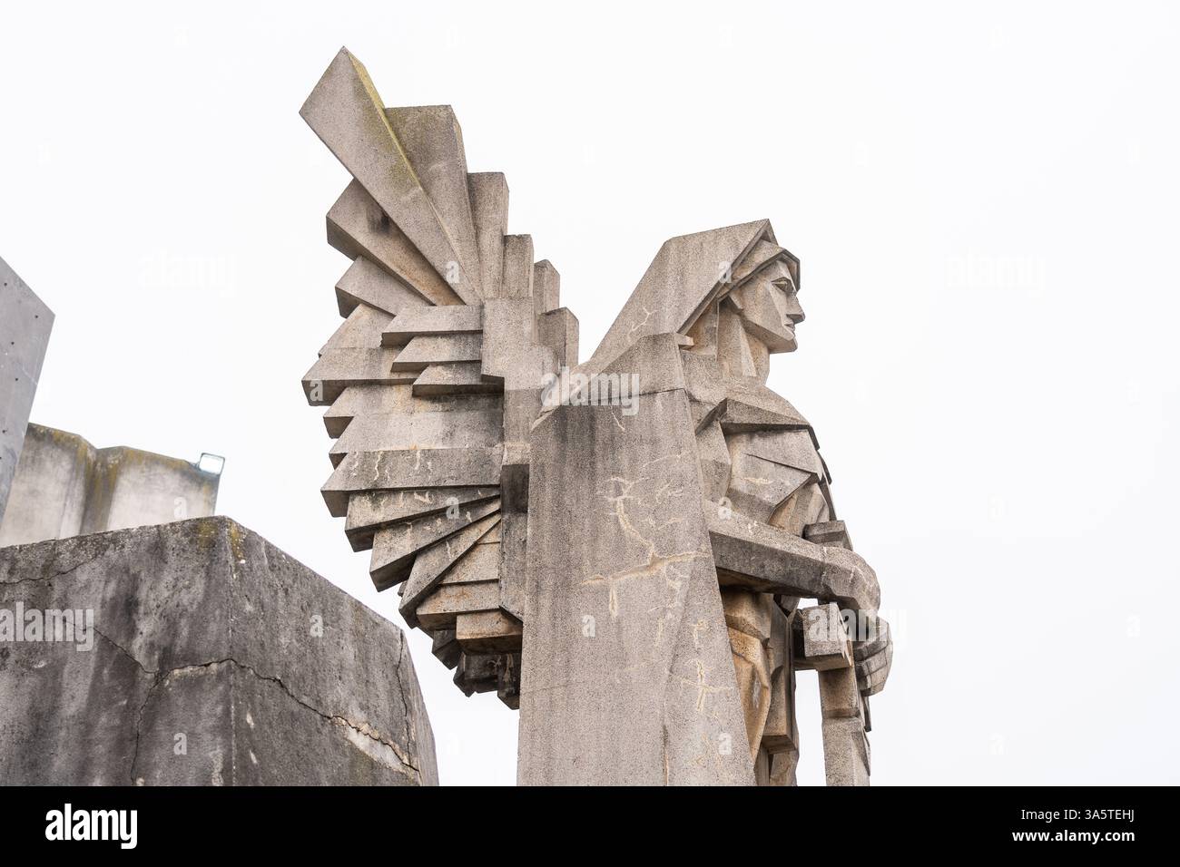 Modernist stone sculpture of a angel warrior with angular details and a ...