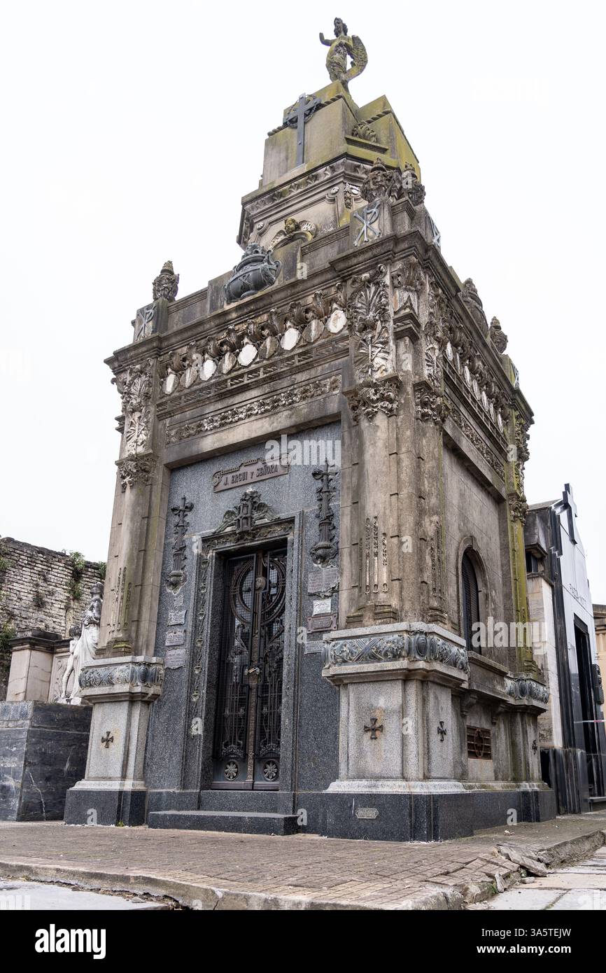 Elegant mausoleums in a historic cemetery with detailed stonework and ...