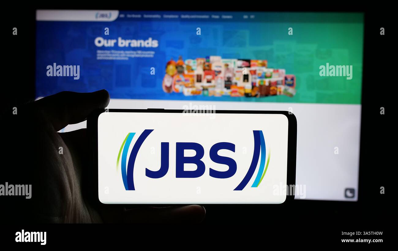 In this photo illustration, a person is holding a cellphone with the ...