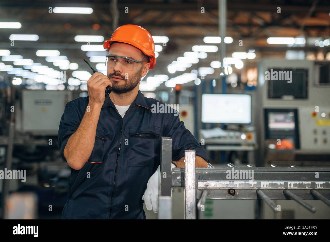Giving instructions, using radio, walkie talkie. Man is working in the ...