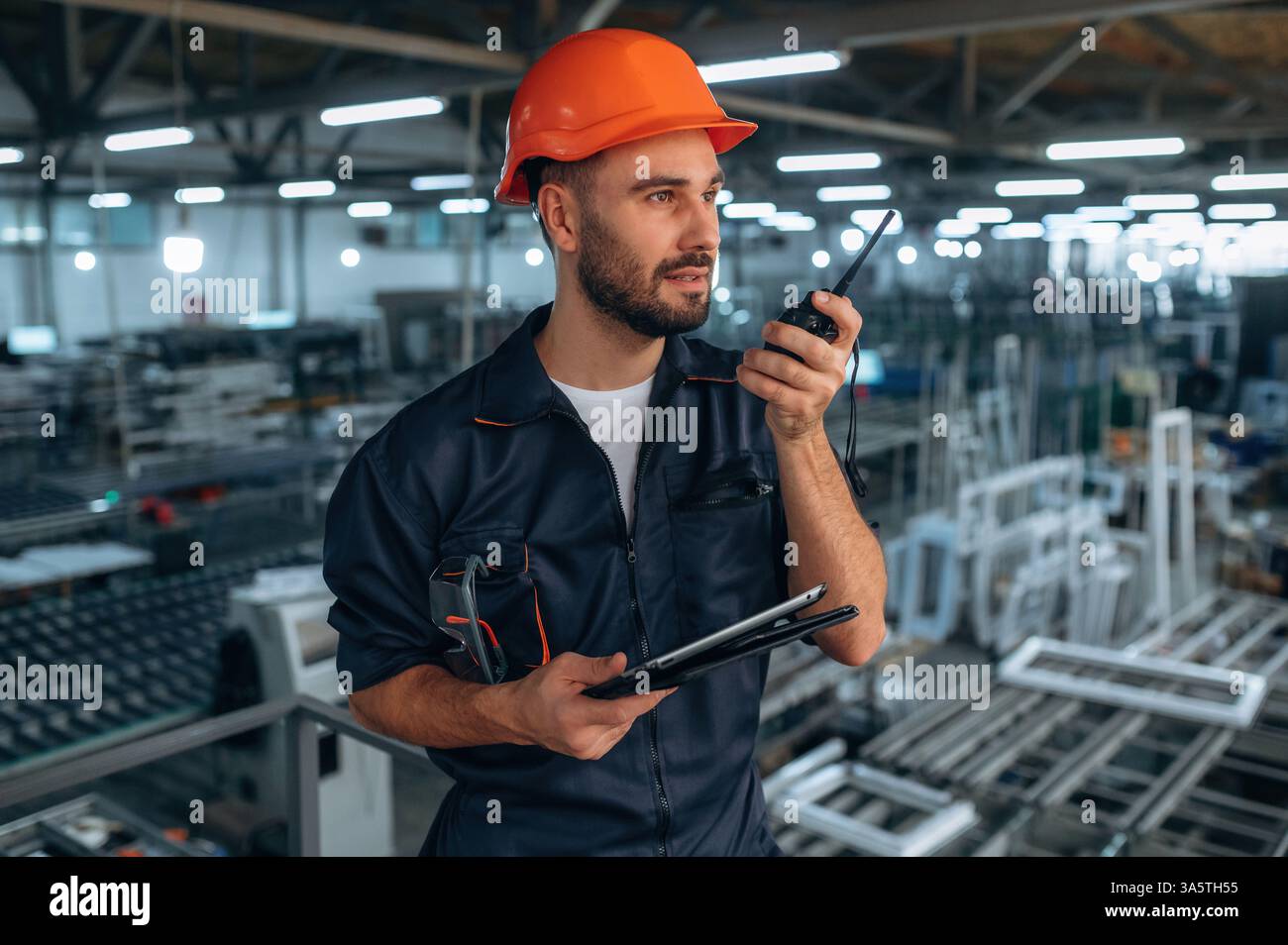 Giving instructions, using radio, walkie talkie. Man is working in the ...