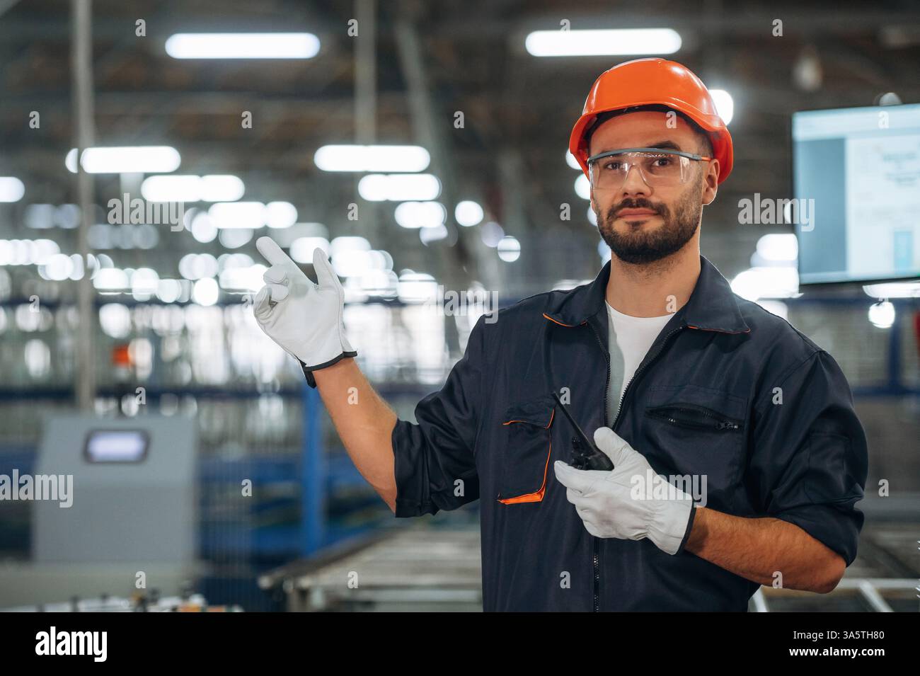 Copy space, showing by the hand. Man is working in the modern factory ...