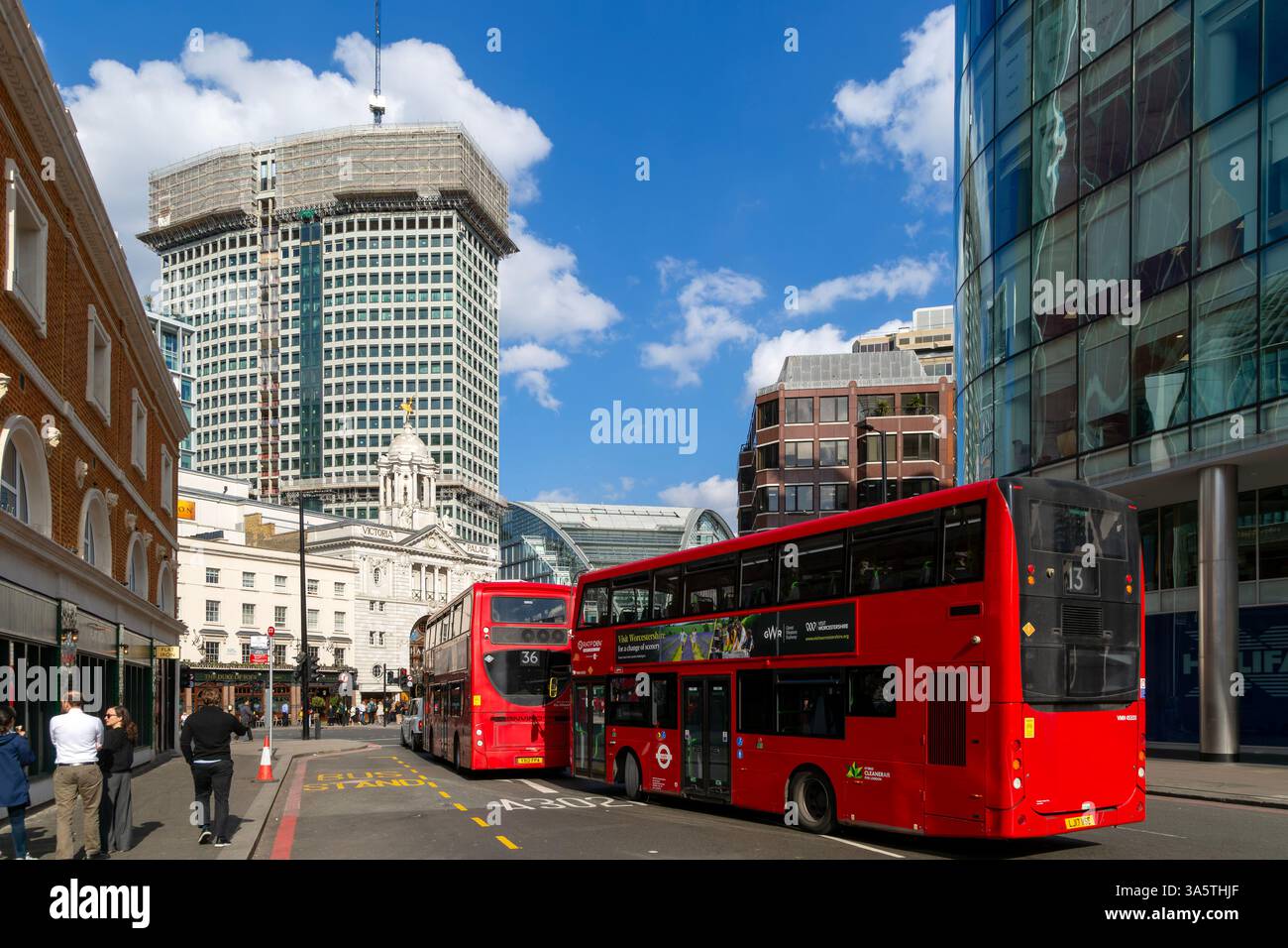 Red double-decker buses in street by Victoria palace theatre, Victoria, Westminster, London ...