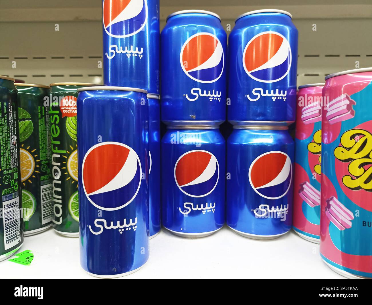 Blue pepsi cans with arabic logos on supermarket shelf display Stock ...