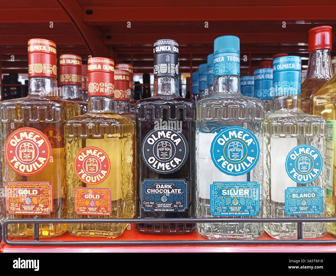 Variety of olmeca tequila bottles displayed on store shelf in different ...