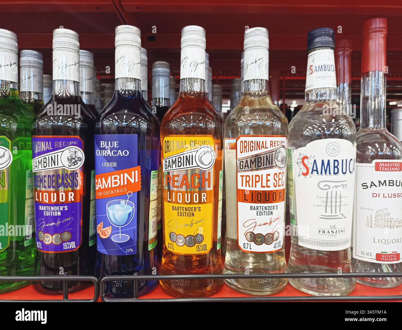 Assorted liquor bottles display on store shelf with vibrant labels ...